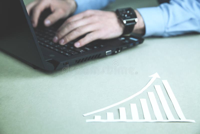 Paper Growth Graph on Desk. Man Using Laptop Stock Image - Image of ...