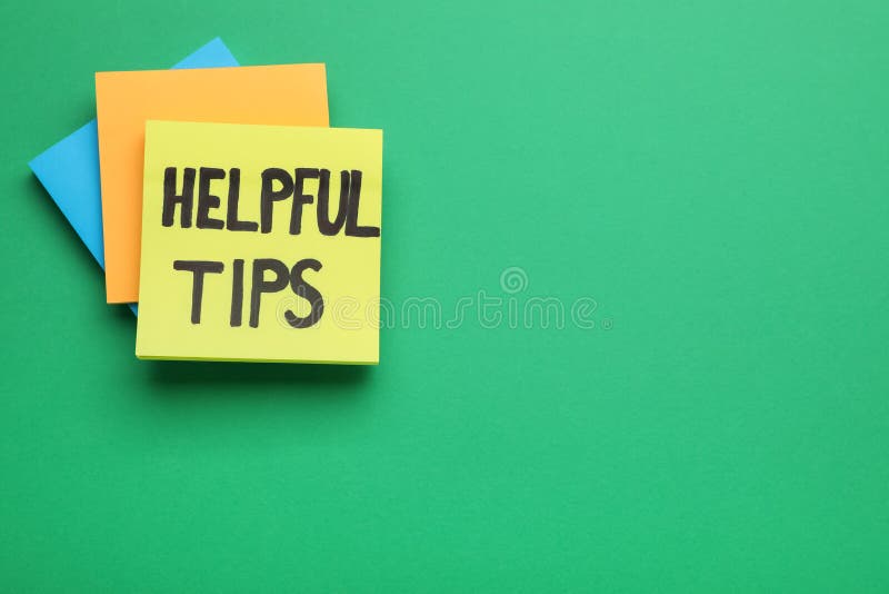 Paper Note with Phrase Helpful Tips on Green Background, Top View ...