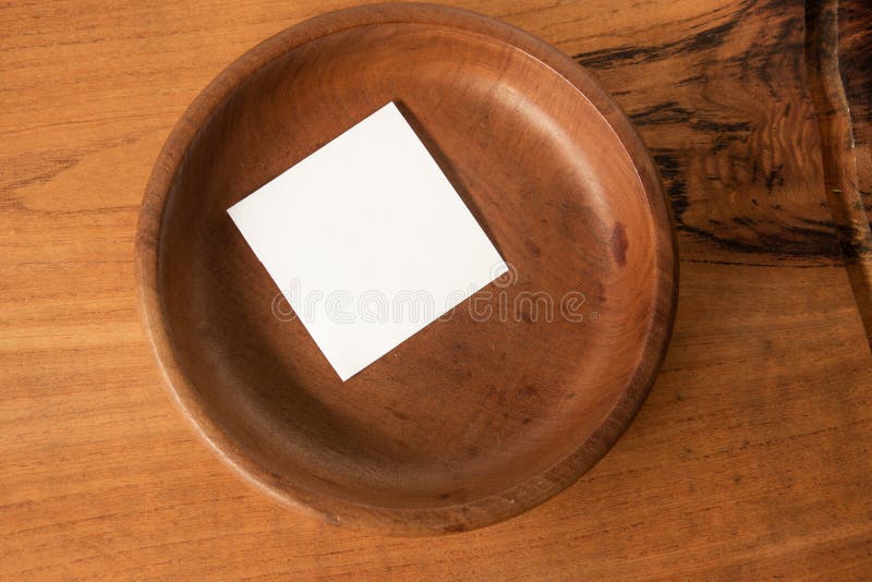 Paper Note on a Wooden Plate Stock Photo - Image of container, table ...