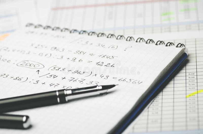 Paper Notebook with Accounting Calculations and Pen on the Background ...