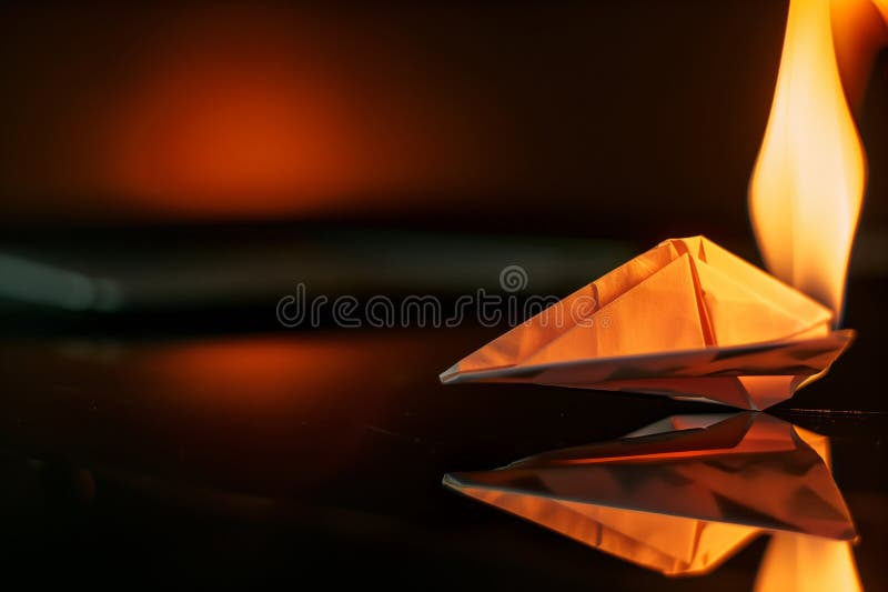 Paper Plane Ablaze on a Reflective Surface Stock Image - Image of flame ...