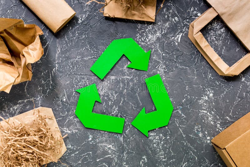 Paper Recycle Sign with Paper and Carton Garbage on Grey Table ...