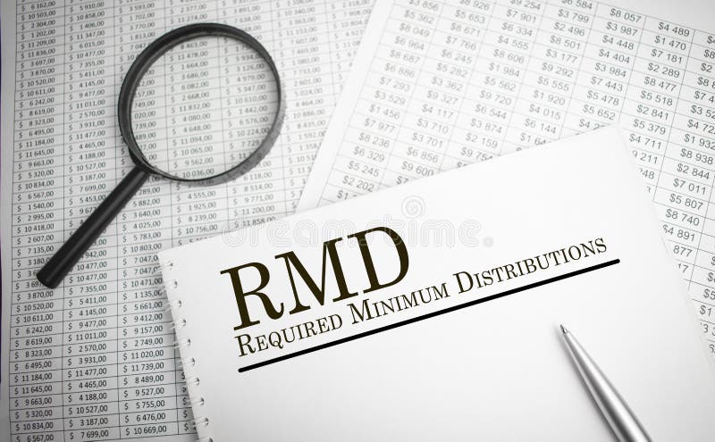 Paper with Required Minimum Distributions RMD on a Table with Pen ...