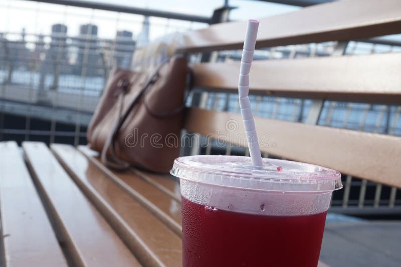 Paper Straw in a Take-out Plastic Cup, on a Bench Stock Image - Image ...