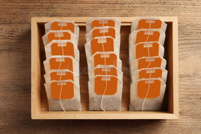Paper Tea Bags with Tags in Box on Wooden Table, Top View Stock Photo ...