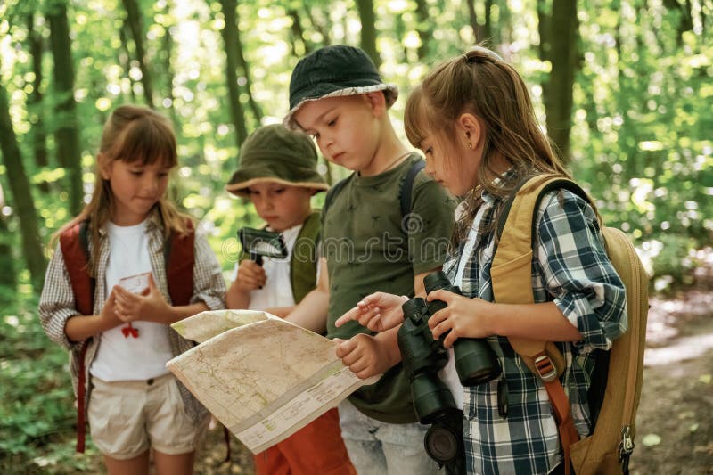 Paper Traditional Map. Kids in Forest at Summer Daytime Together Stock ...