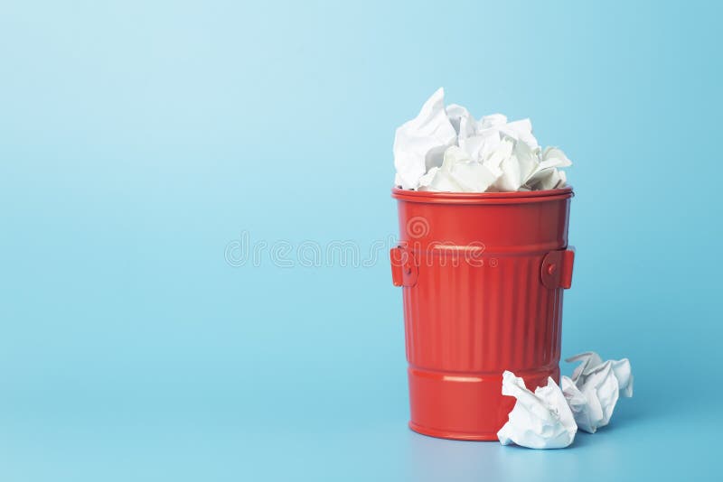 Paper Trash and Waste in a Trash Bin on a Blue Background. Waste and ...