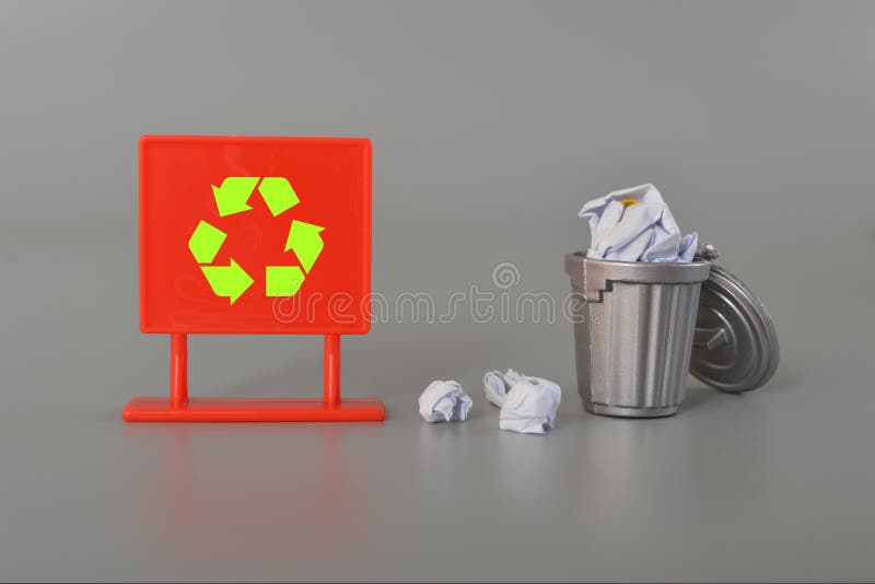 Paper Waste Loaded into a Recycling Bin with the Appropriate Recycle ...