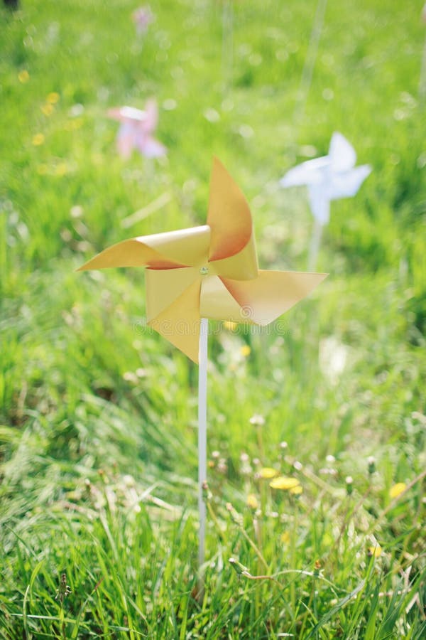 Paper Windmill in Green Grass Field Stock Photo - Image of summer, wind ...