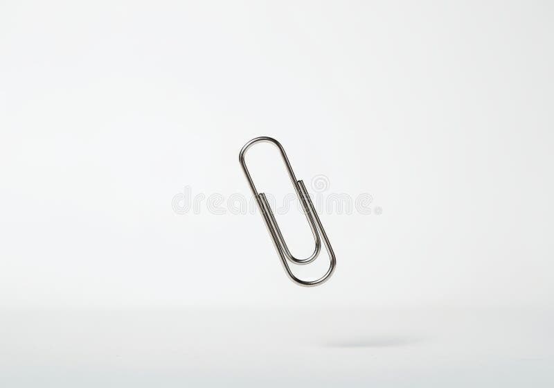 A Paperclip Floating Mid-air, on a Solid White Background Stock ...
