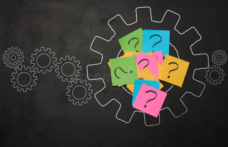 Papers with a Drawn Question Mark and Gears on a Black Chalk Board ...
