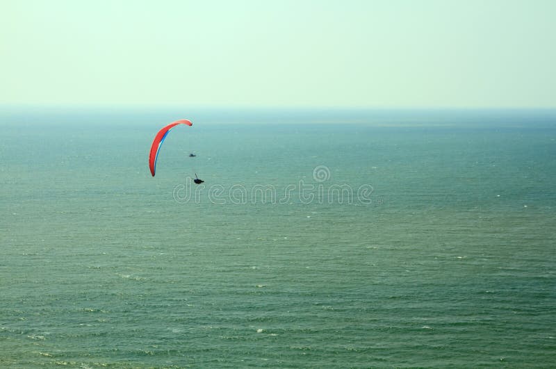 Para Glider Flying in Blue Sky Over the Ocean. Stock Image - Image of ...