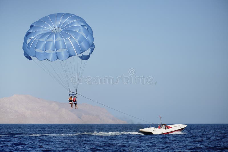 Parachute Flight Over the Water Against the Background of Mountains ...