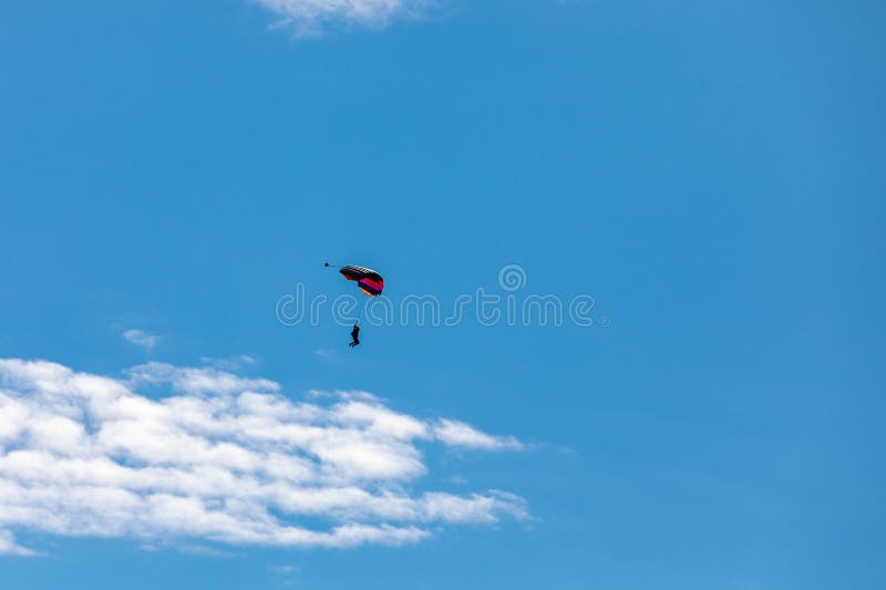 Parachute in the Sky. Skydiver is Flying a Parachute in the Blue Sky ...