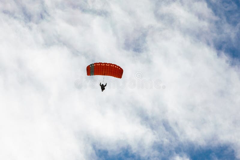 Parachute in the Sky. Skydiver is Flying a Parachute in the Blue Sky ...