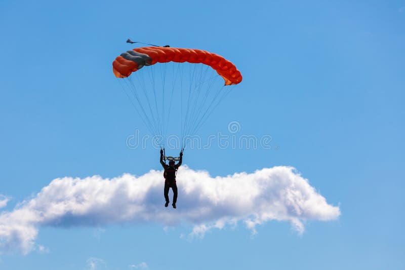 Parachute in the Sky. Skydiver is Flying a Parachute in the Blue Sky ...