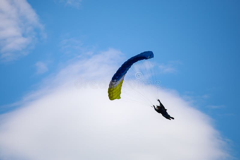 Parachute in the Sky. Skydiver is Flying a Parachute in the Blue Sky ...