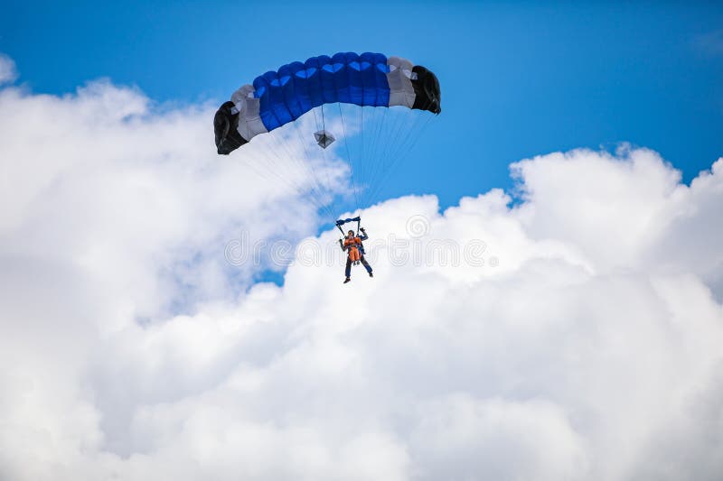 Parachute in the Sky. Skydiver is Flying a Parachute in the Blue Sky ...