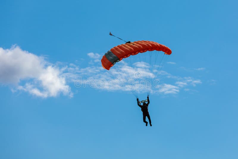 Parachute in the Sky. Skydiver is Flying a Parachute in the Blue Sky ...