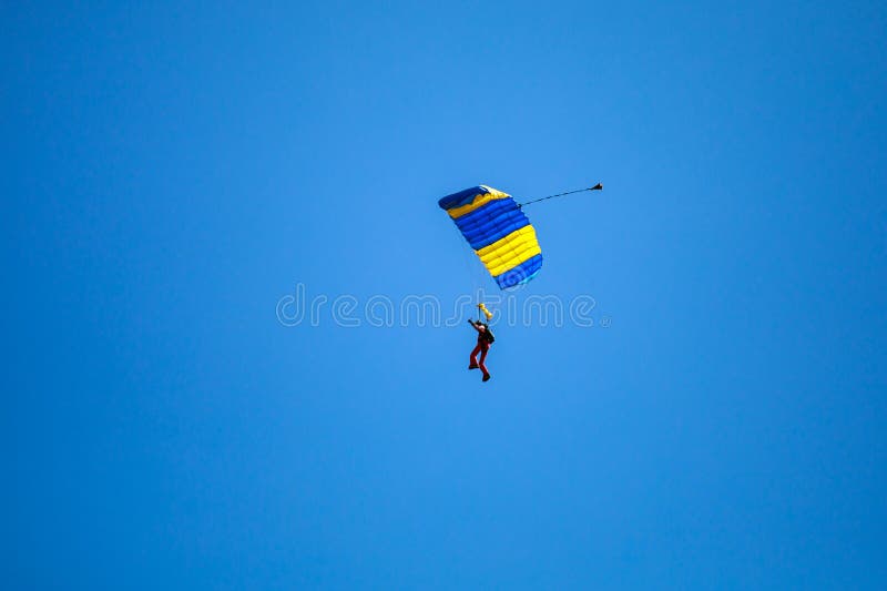 Parachute in the Sky. Skydiver is Flying a Parachute in the Blue Sky ...