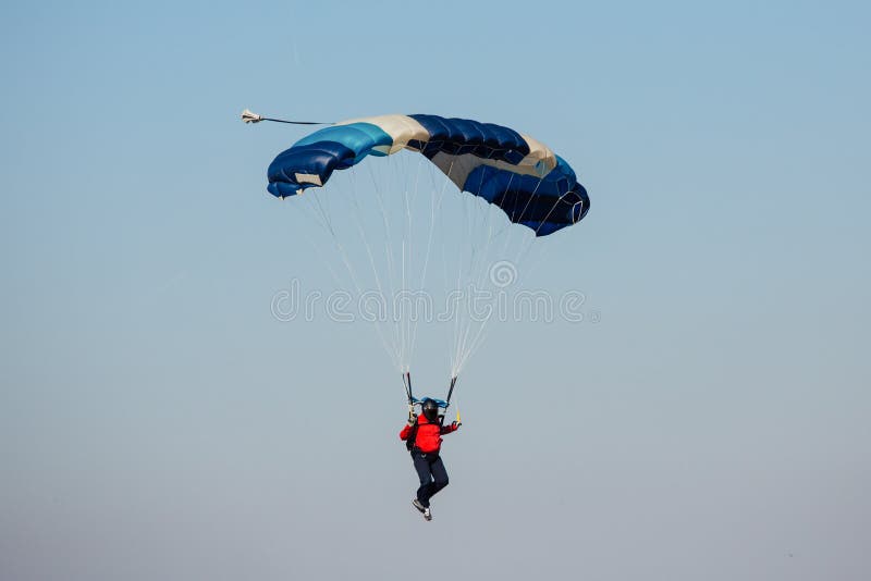 Parachute in the Sky. Skydiver is Flying a Parachute in the Blue Sky ...