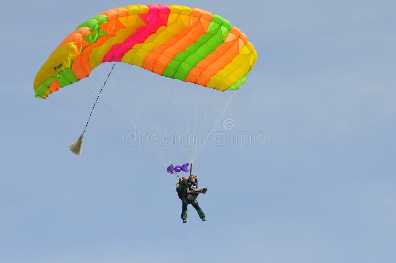 The Parachutist Goes Down on a Multi-colored Parachute. Editorial ...