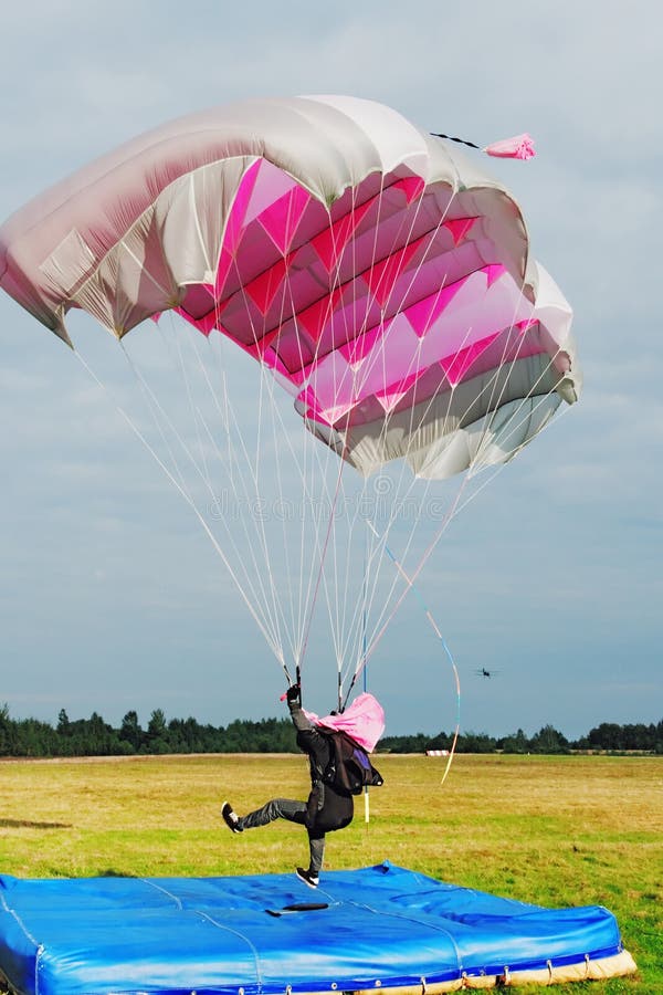 Parachutist Landing Under a Pink Parachute Stock Image - Image of ...
