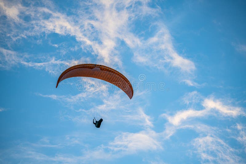 Paraglider Flying Under the Blue Sky Against the Background of Clouds ...