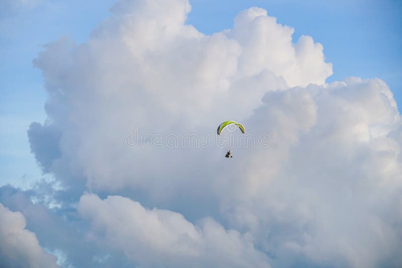 Paraglider with Motor Flying in the Cloudy Sky. Tiny Cloud Floating ...