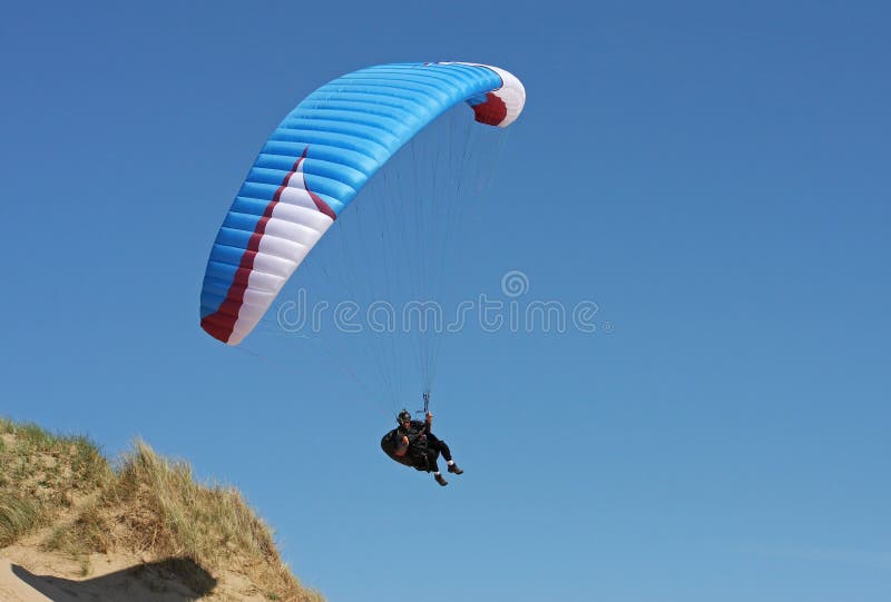 Paraglider over sand dunes stock image. Image of paragliding - 40241017