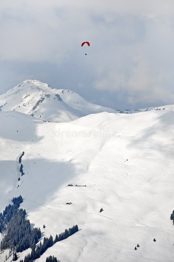 Paragliding Above Snow Covered Mountains in the Alps Stock Image ...