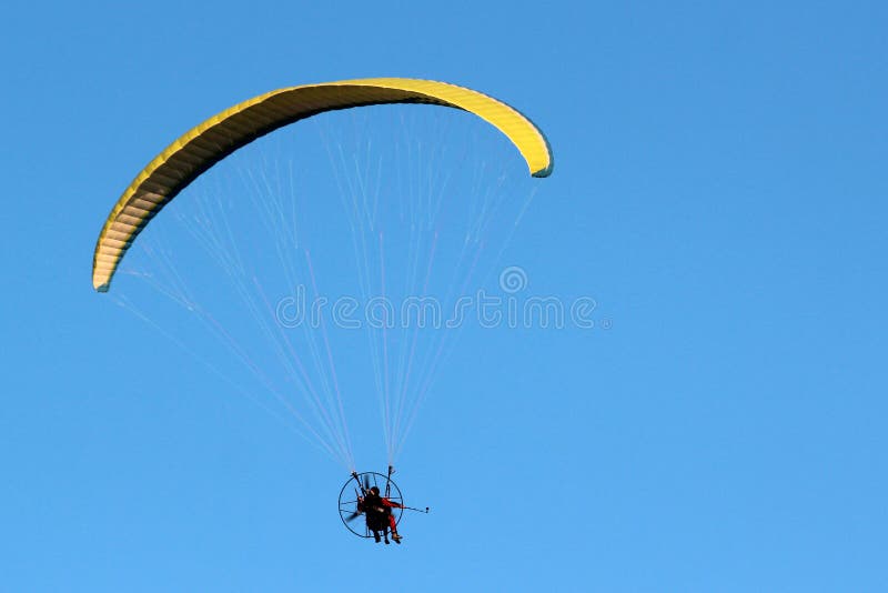 Paragliding in a Blue Sky, Pilot Controls Motorized Flying Machine ...