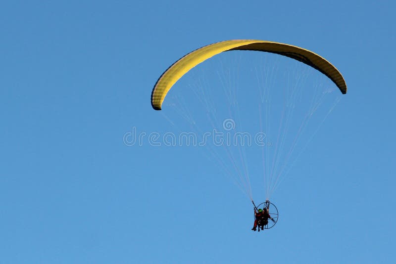Paragliding in a Blue Sky, Pilot Controls Motorized Flying Machine ...