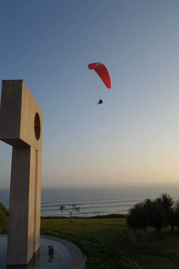 Paragliding Over the Ocean and Statue Stock Photo - Image of sunset ...