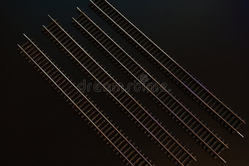 Parallel Model Train Tracks on Dark Background Stock Photo - Image of ...