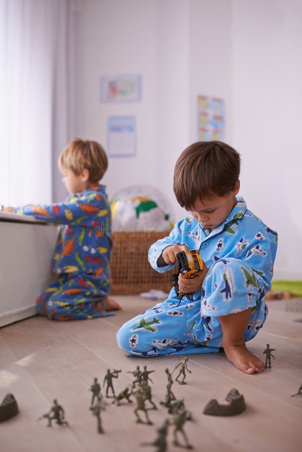 Parallel Play. Two Brothers Sitting on the Floor Playing Separately ...