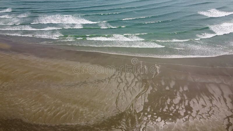 Parallel Waves Break on the Shore, Creating a Repeating Pattern of ...