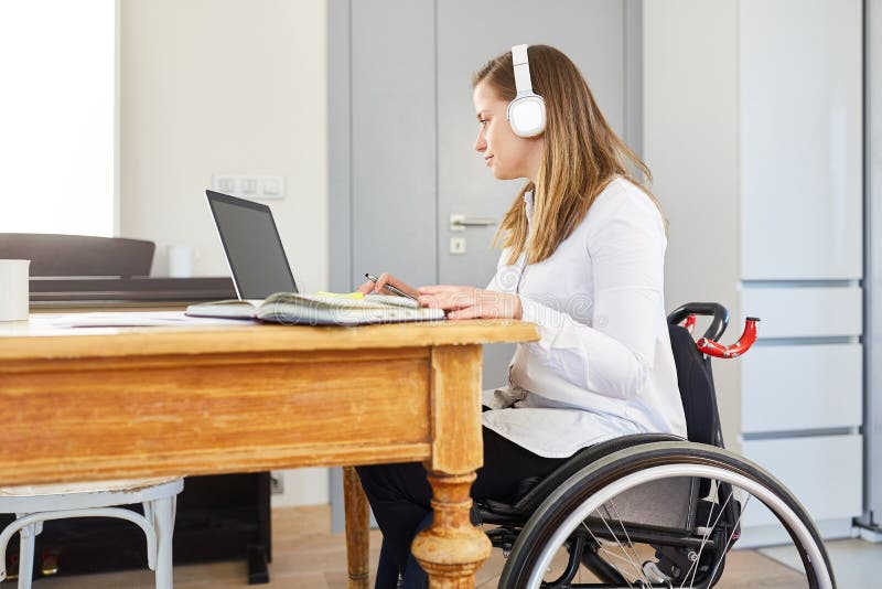 Paralyzed Student in a Wheelchair Doing E-learning on the Computer ...