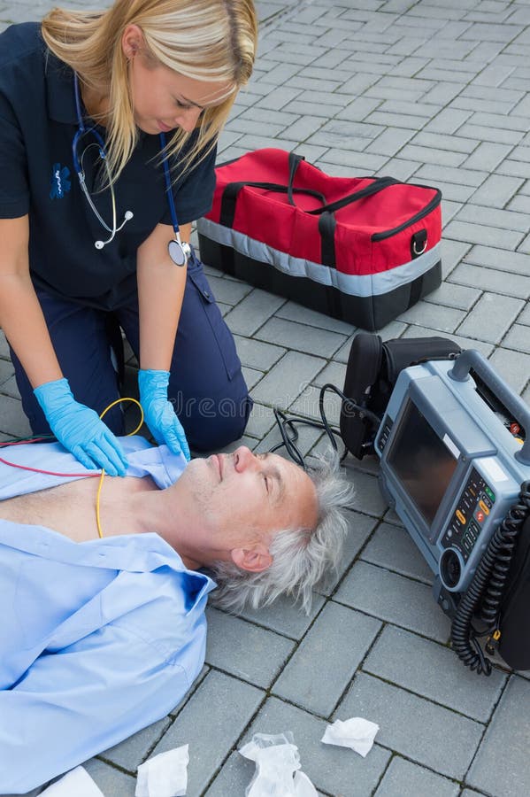 Paramedic Examining Unconscious Patient Stock Photo - Image of ...