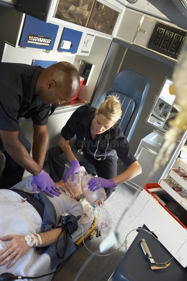Paramedic with Patient in Ambulance Stock Photo - Image of gurney ...