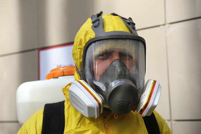 Paramedic Wearing Yellow Protective Costume and Mask Disinfecting ...