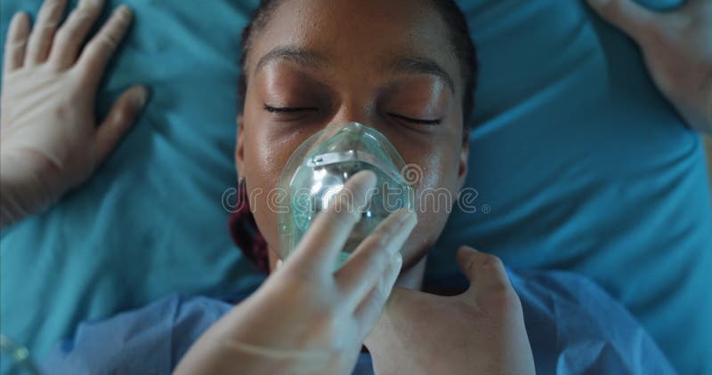 Paramedics Checking Pulse And Putting Oxygen Inhalation Mask On Girl