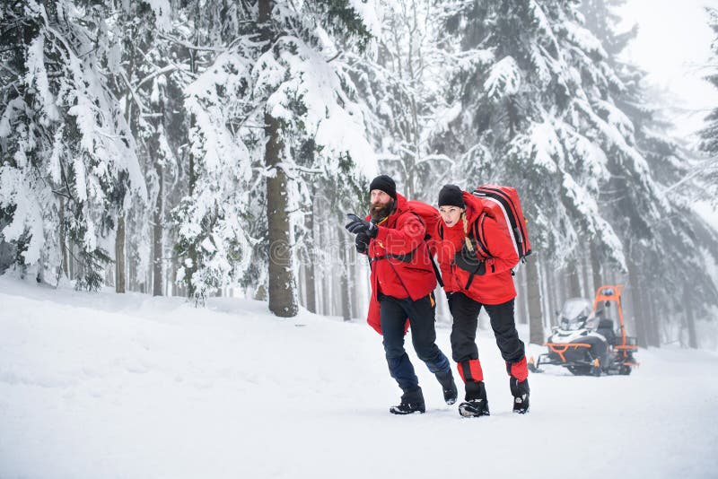 Paramedics from Mountain Rescue Service Walking Outdoors in Winter in ...