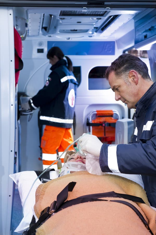 Paramedics Checking IV Drip Patient in Ambulance Stock Image - Image of ...