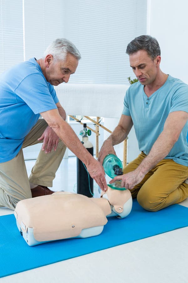 Paramedics Practicing Cardiopulmonary Resuscitation on Dummy Stock ...