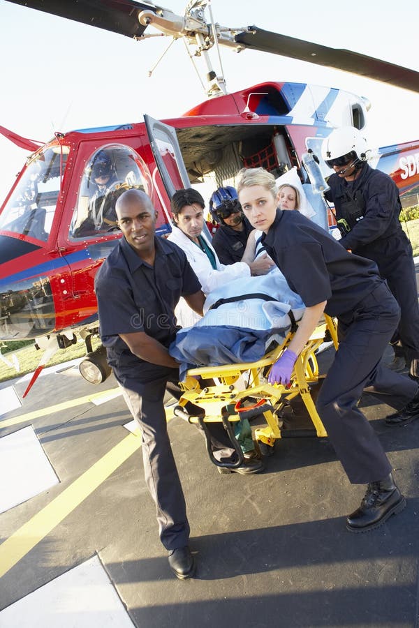 Paramedics Unloading Patient from Helicopter Stock Image - Image of ...