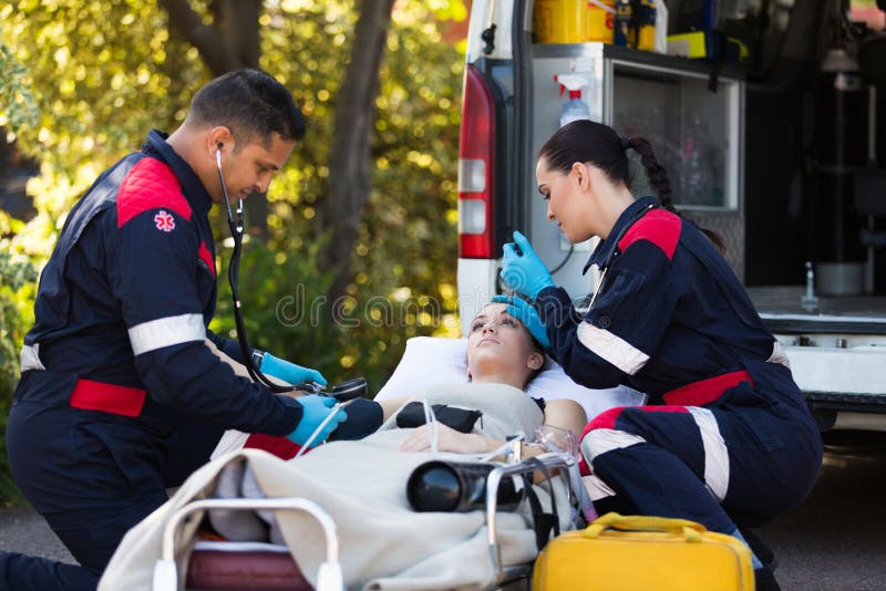 Paramedics Checking IV Drip Patient in Ambulance Stock Image - Image of ...