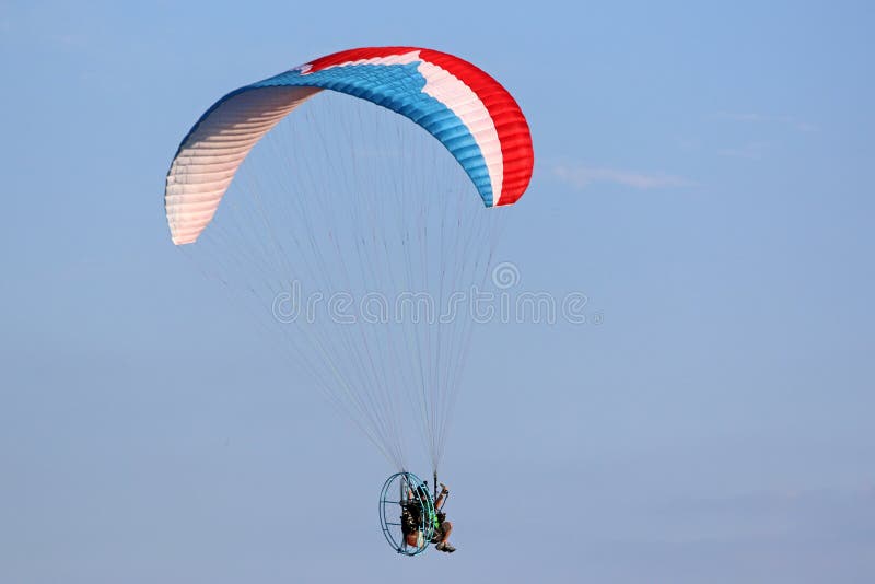 Paramotor Pilot Flying in a Blue Sky Stock Photo - Image of paraglider ...