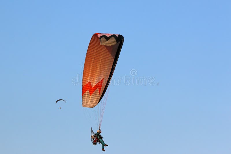 Paramotor Pilot Flying in a Blue Sky Stock Photo - Image of paraglider ...