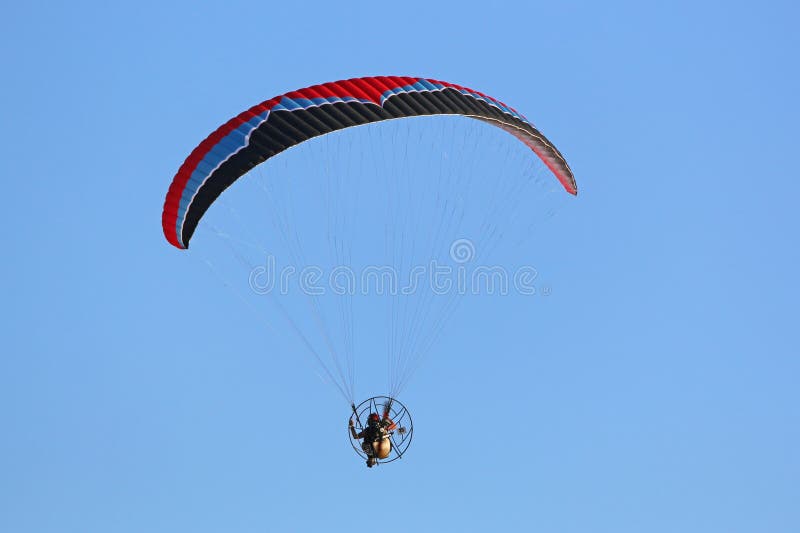 Paramotor Pilot Flying in a Blue Sky Stock Photo - Image of transport ...